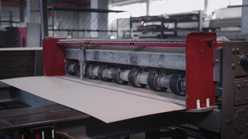 Industrial Machine for Cutting Sheets of Cardboard. Production of Cardboard Boxes for Packaging ...
