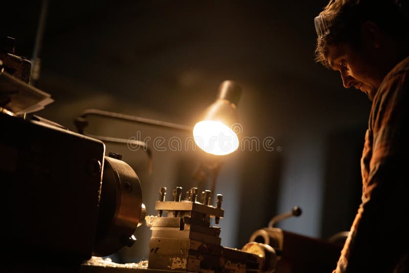 Industrial Man Working Indoors in Metal Workshop at Night. Stock Photo ...