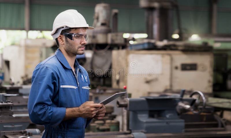 Industrial Mechanics are Working in Front of a Factory Machine ...
