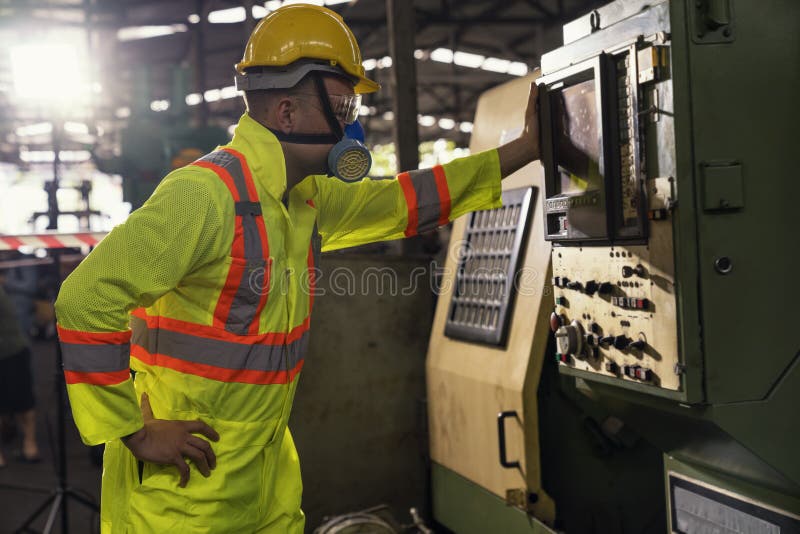 Industrial Mechanics are Working in Front of a Factory Machine. Young ...