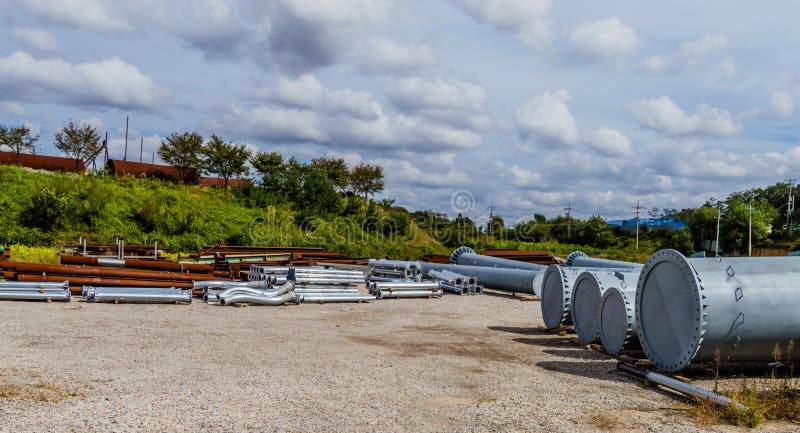 Industrial Pipe Storage Lot Under a Sky Filled with White Puffy Stock ...
