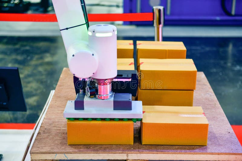 Industrial Robot Holding a Box Operating a Robot Machine on Stock Stock ...
