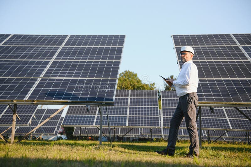 Industrial Senior Man Engineer Walking through Solar Panel Field for ...