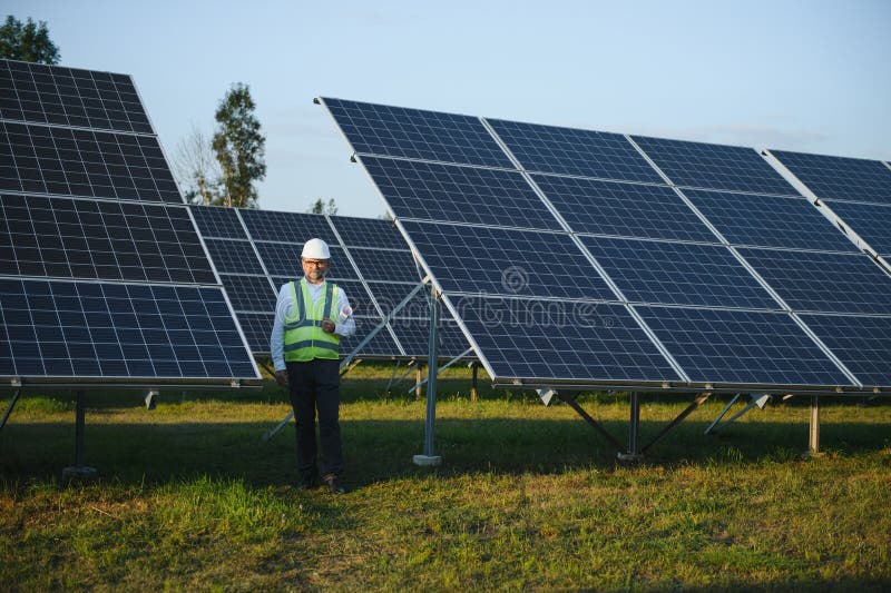 Industrial Senior Man Engineer Walking through Solar Panel Field for ...