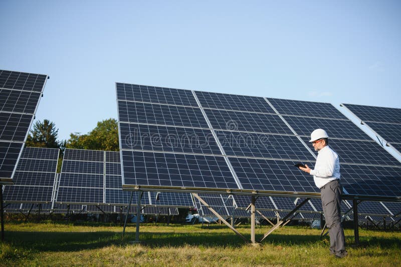Industrial Senior Man Engineer Walking through Solar Panel Field for ...