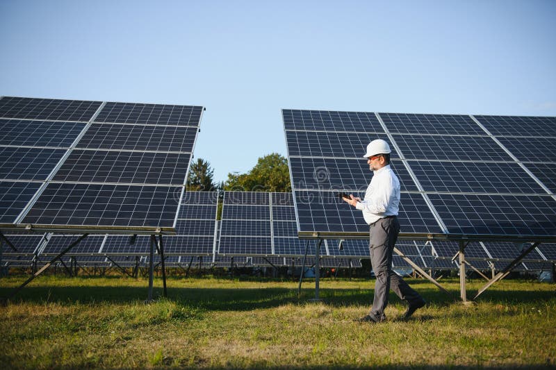 Industrial Senior Man Engineer Walking through Solar Panel Field for ...