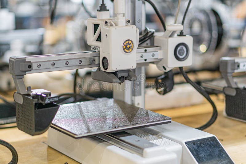 Industrial Setting Featuring a Flexible Robotic Arm, Positioned Over a ...