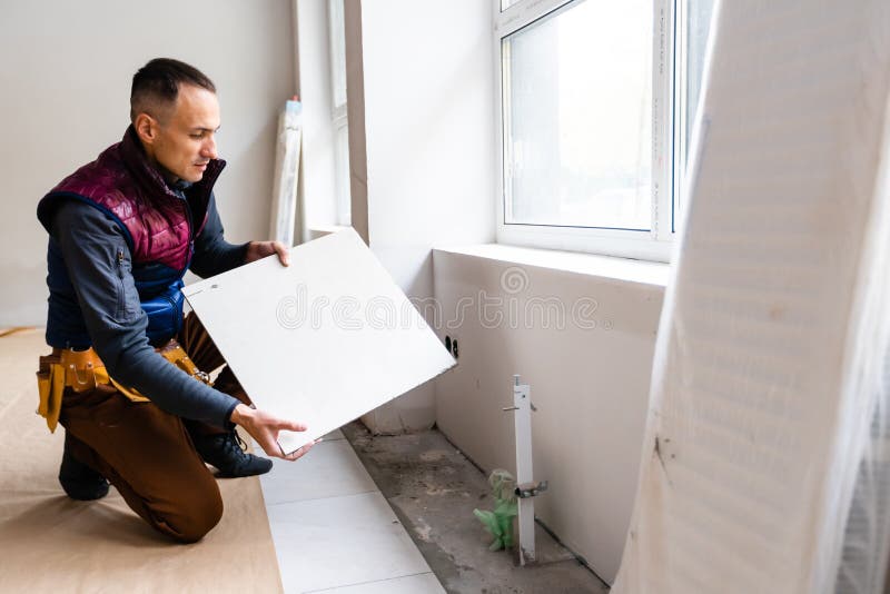 Industrial Tiler Builder Worker Installing Floor Tile at Repair ...