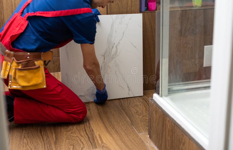 Industrial Tiler Builder Worker Installing Floor Tile at Repair ...