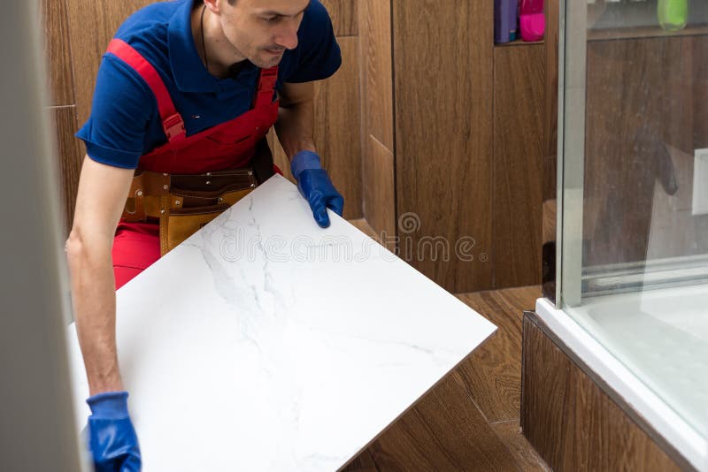Industrial Tiler Builder Worker Installing Floor Tile at Repair ...