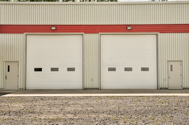 Industrial Warehouse with White Roller Doors. Stock Photo - Image of ...