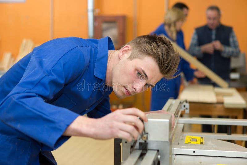 Industrial Woodworking Apprentice Adjusting Machine Stock Photo - Image ...