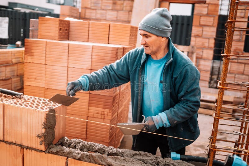 Construction Bricklayer Worker Smiling and Building Walls with Bricks ...