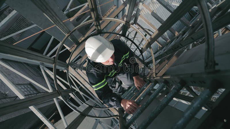 Industrial Worker Climbing Ladders Up. Top View, Worker with Hard Hat ...