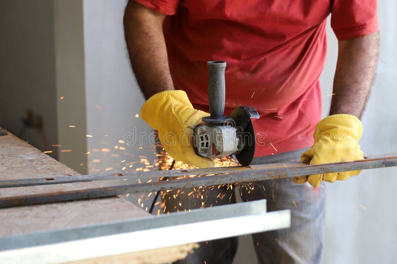 Industrial Worker Cutting Iron with a Grinder that Produces Sparks ...