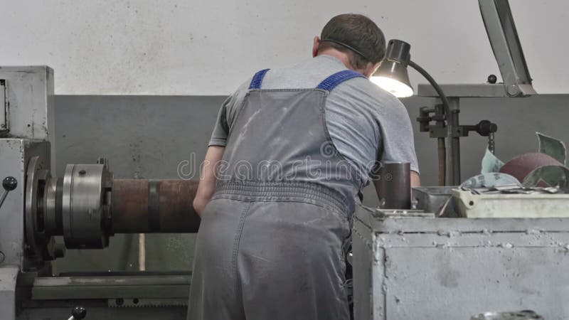 Video 4k. Industrial Worker Operating a Machine in a Workshop ...