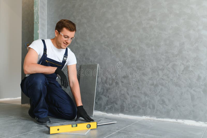 Industrial Worker, Handyman Installing Big Ceramic Tiles Stock Image ...