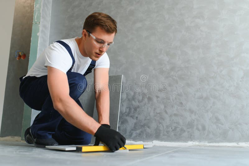 Industrial Worker, Handyman Installing Big Ceramic Tiles Stock Photo ...