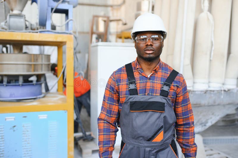 Industrial Worker Indoors in Factory. Young Technician with White Hard ...