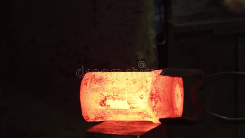 Industrial Worker Manipulates Glowing Metal Billet in Forge, Hammering ...