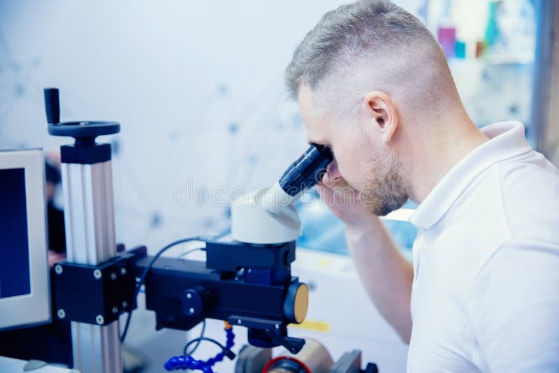 Industrial Worker Use Microscope for Precision Plasma Welding at Modern ...