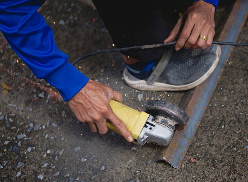 Industrial Worker Using Angle Grinder and Cutting a Metal Stock Photo ...