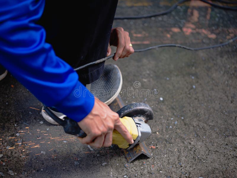 Industrial Worker Using Angle Grinder and Cutting a Metal Stock Photo ...