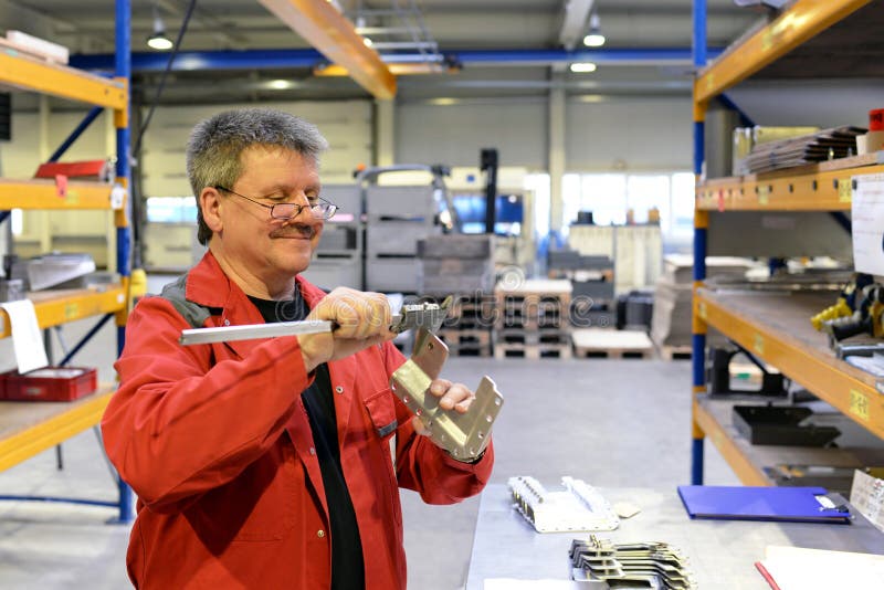 Industrial Workers Inspect Work Piece for Accuracy with Measuring ...