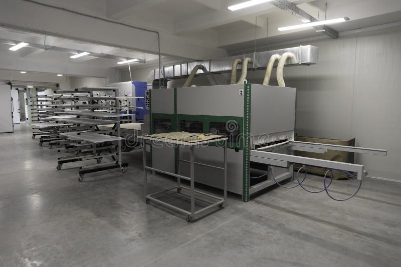 Industrial Workshop Featuring a Large Machine and Shelving Units for ...