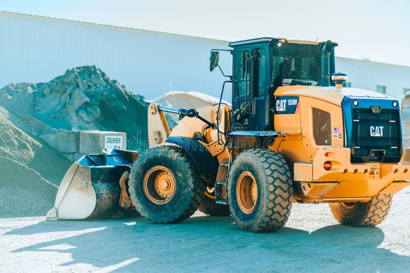 Industrial Yellow and Black Machine is Positioned in Front of a Large ...