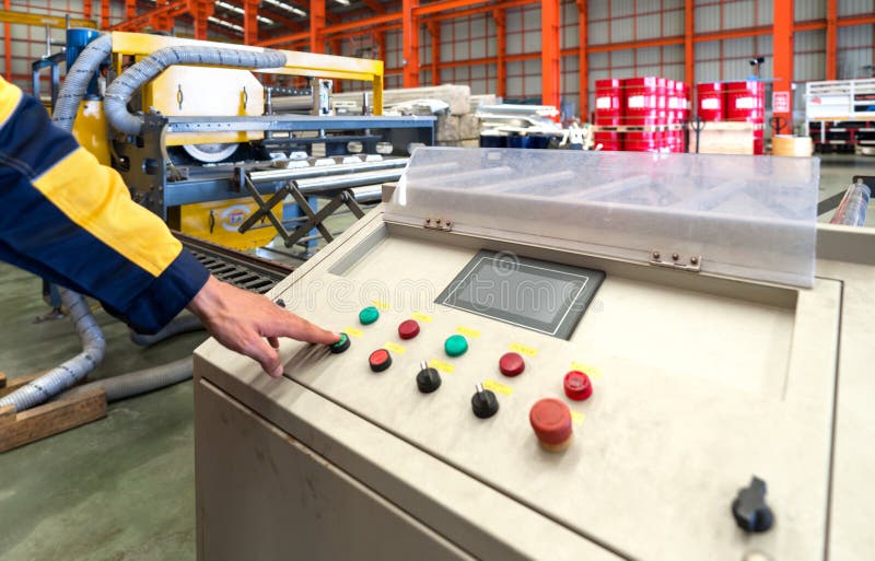 Industrious Worker Meticulously Operating Complex Machinery within a ...