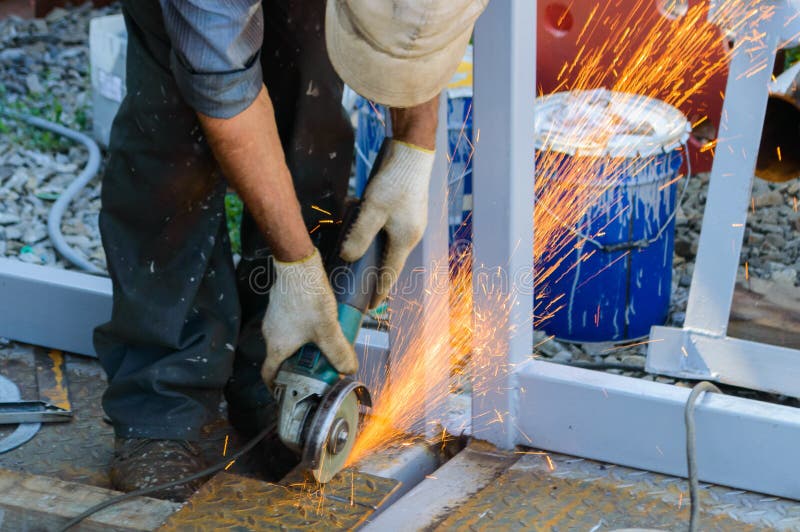 A Industry Construction Worker Using an Angle Grinder for Cut of Stock ...