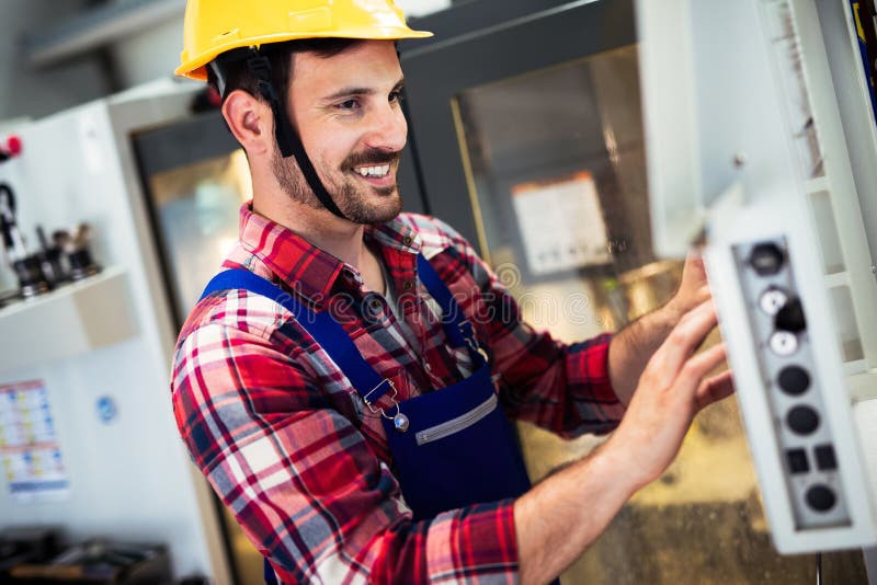 Industry Worker Entering Data in CNC Machine at Factory Stock Photo ...