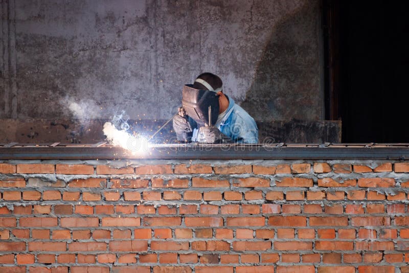 Industry Worker Welding Iron Pieces on New Building Stock Image - Image ...