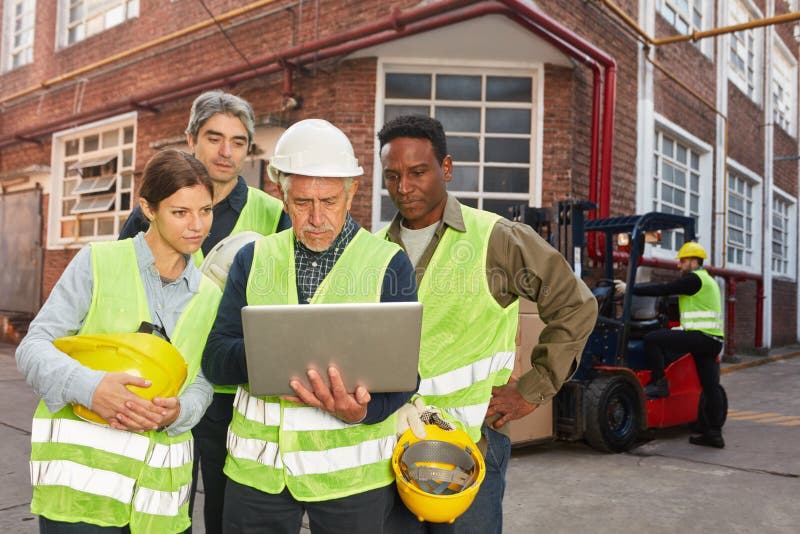 Industry Workers Team Using Computer in Front of Factory Stock Image ...