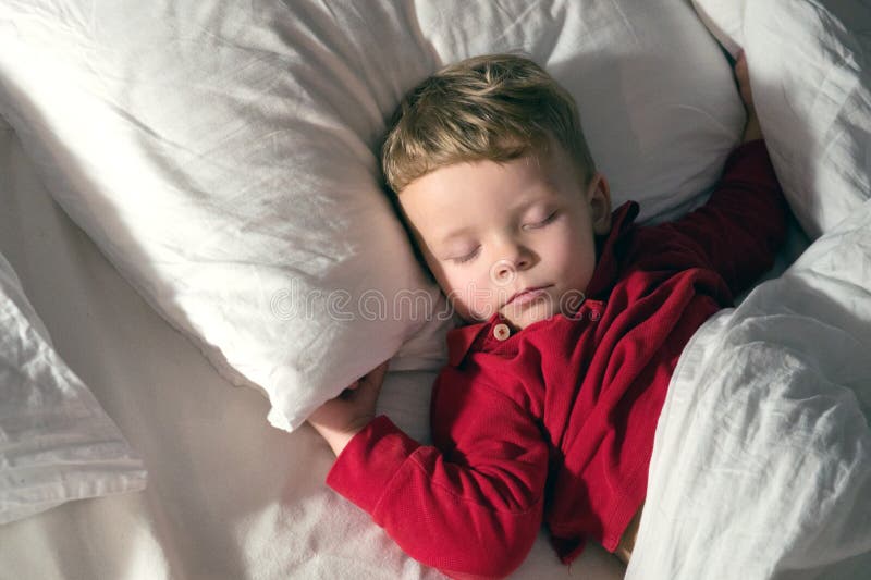 Little Boy Lying and Sleeping on the Bed with Laptop at Night. the ...