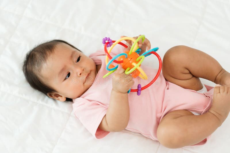 .infant Baby with Colorful Rubber Bites Toy on Bed Stock Image - Image ...