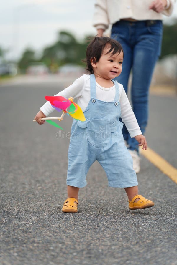 Infant Baby Learn Walking First Step on Pathway with Mother Helping ...
