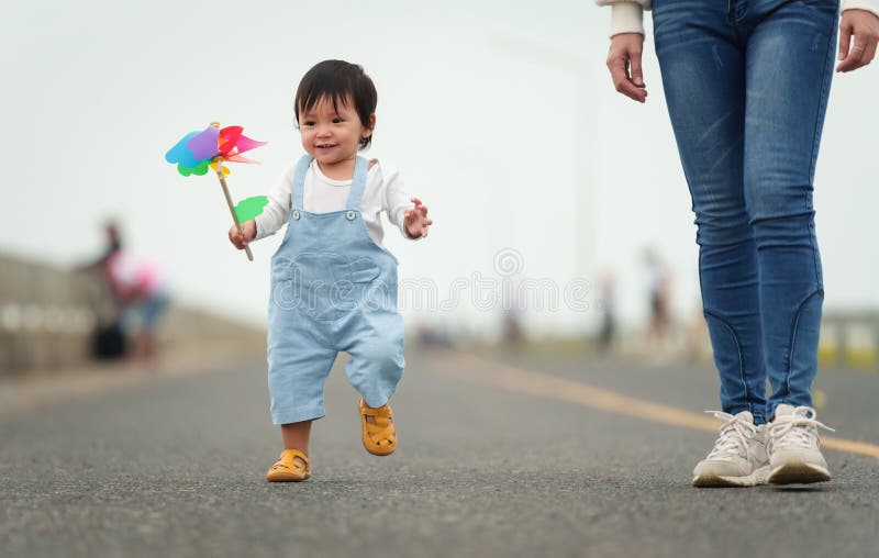 Infant Baby Learn Walking First Step on Pathway with Mother Helping ...