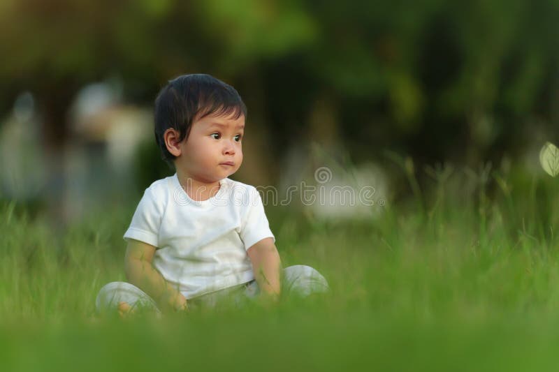 Infant Baby Sitting on Green Grass Field at the Park Stock Image ...