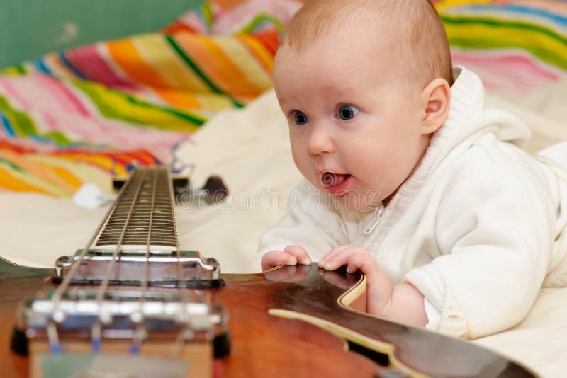 Infant and the bass guitar stock photo. Image of focus - 6587878