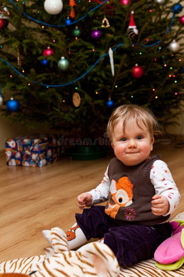 Infant and Christmas Tree stock photo. Image of tree - 17628462