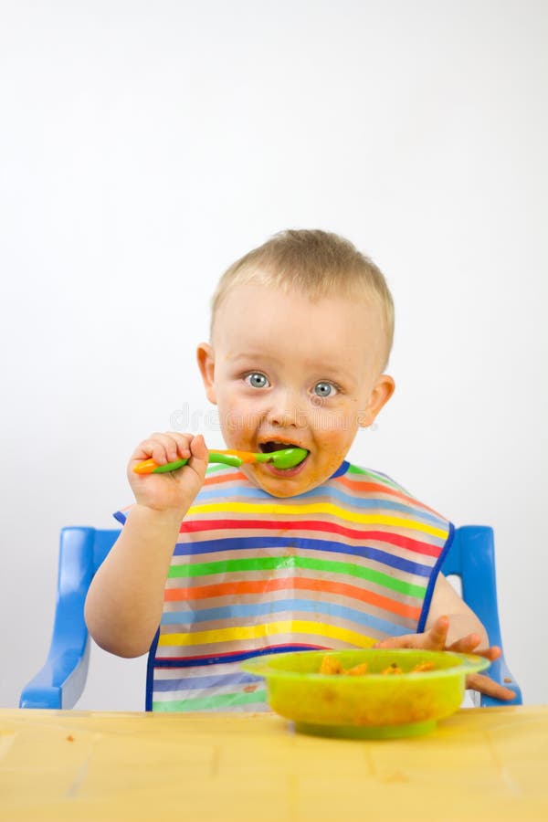 Infant Eating His First Meals Stock Image - Image of baby, camera: 23470963