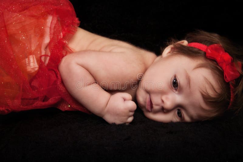 Infant Girl in Red stock image. Image of laying, color - 19039535