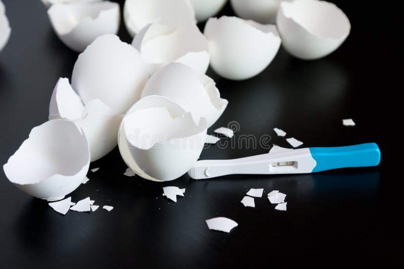 Infertility. Negative Pregnancy Test and Eggshell on Black Background ...