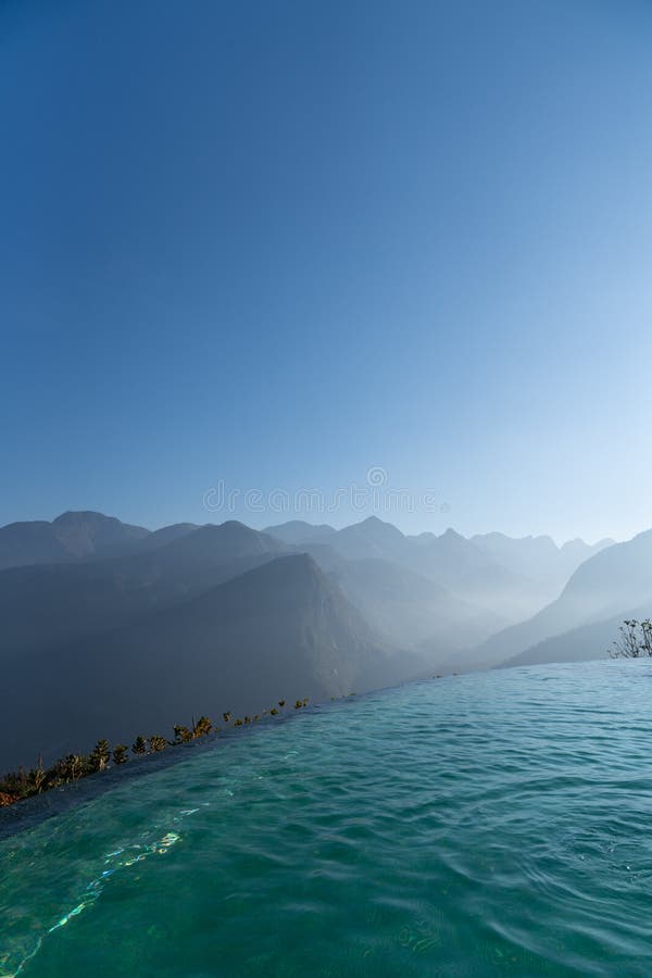Infinity Edge Pool with Layer of Mountain in the Background / Landscape ...