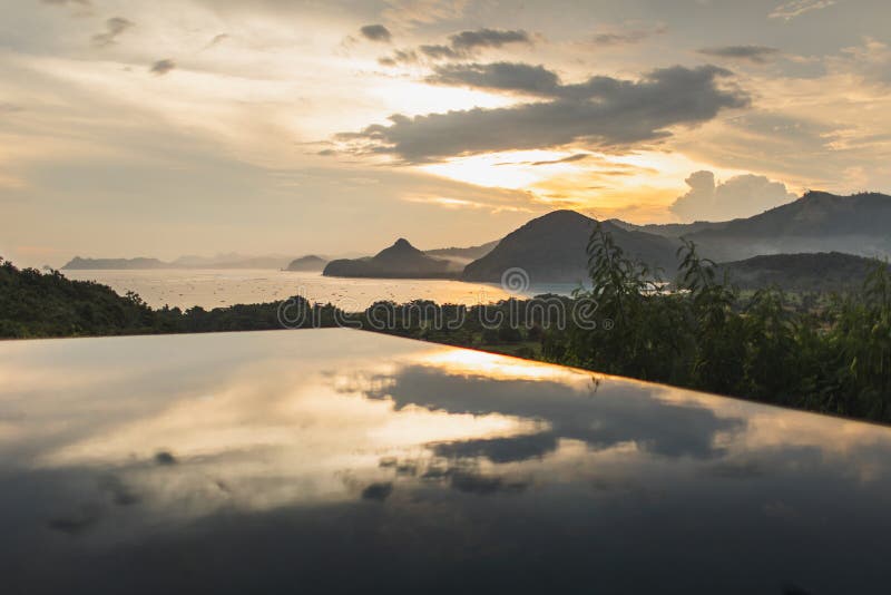 Infinity Pool with Amazing Mountain and Ocean View at Sunset Stock ...