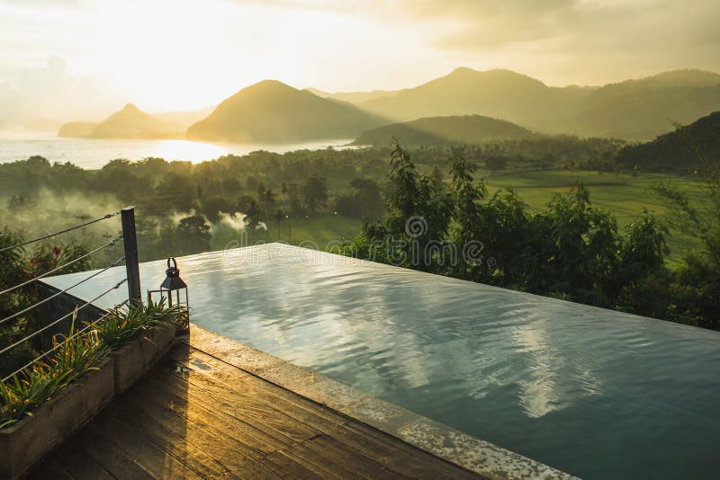 Infinity Pool with Amazing Mountain and Ocean View at Sunset Stock ...