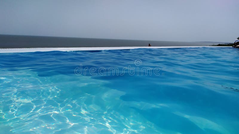 Infinity Pool with Blue Water Overlooking the Sea Stock Photo - Image ...