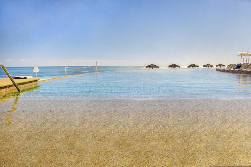 Infinity Pool on the Beach stock image. Image of vacation - 275484333